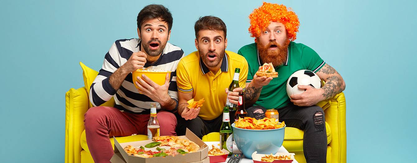 Why do we like to eat snacks while watching sports?